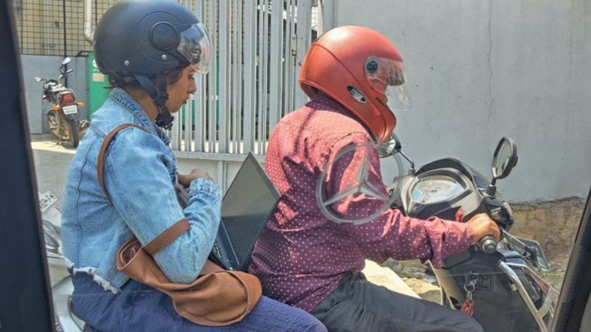Women working on her laptop on scooty Rapido ride in Bengaluru traffic jam, Photo goes viral ...
